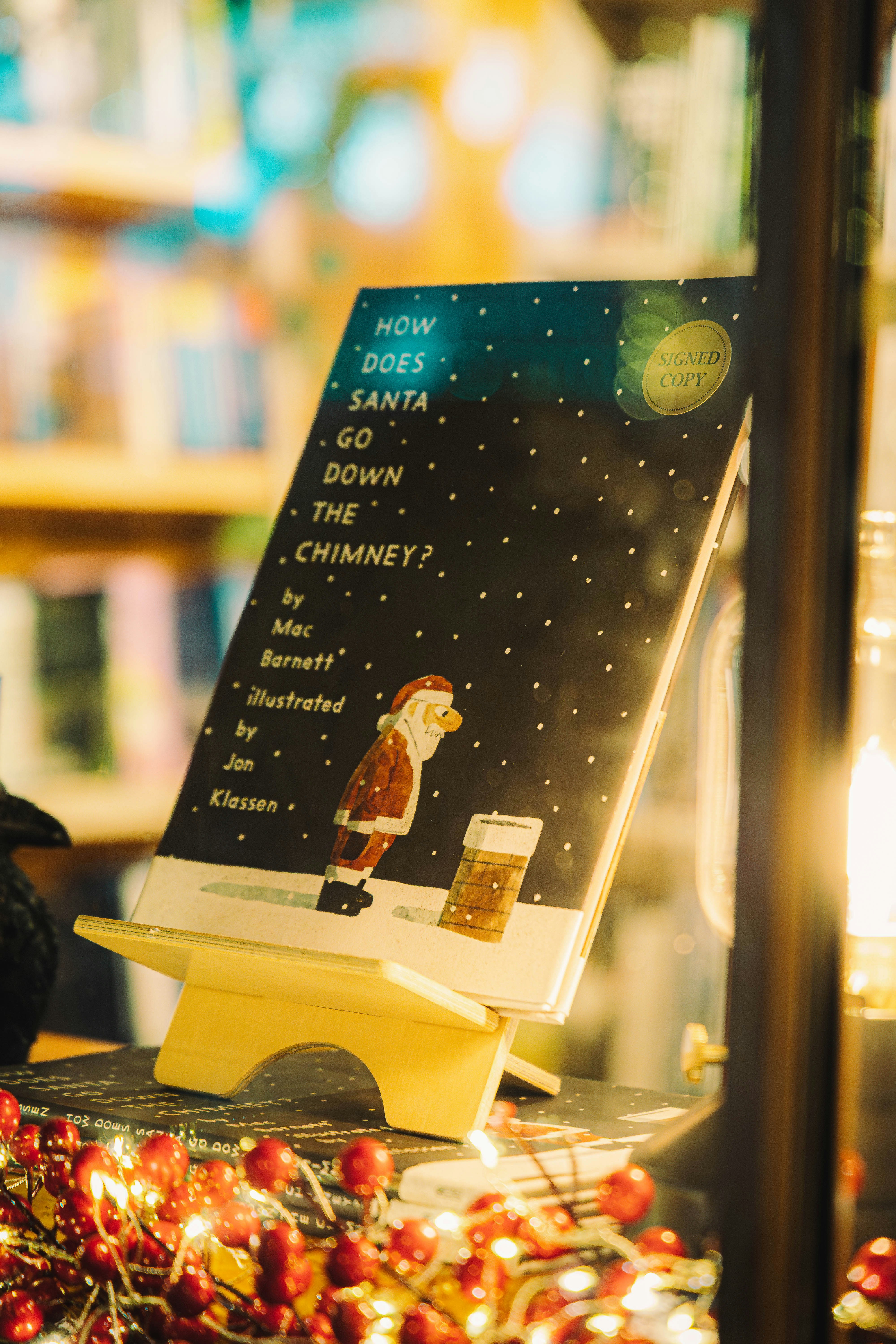 Santa’s Chimney Visit: A Cozy Book Display in Soft Neon Light