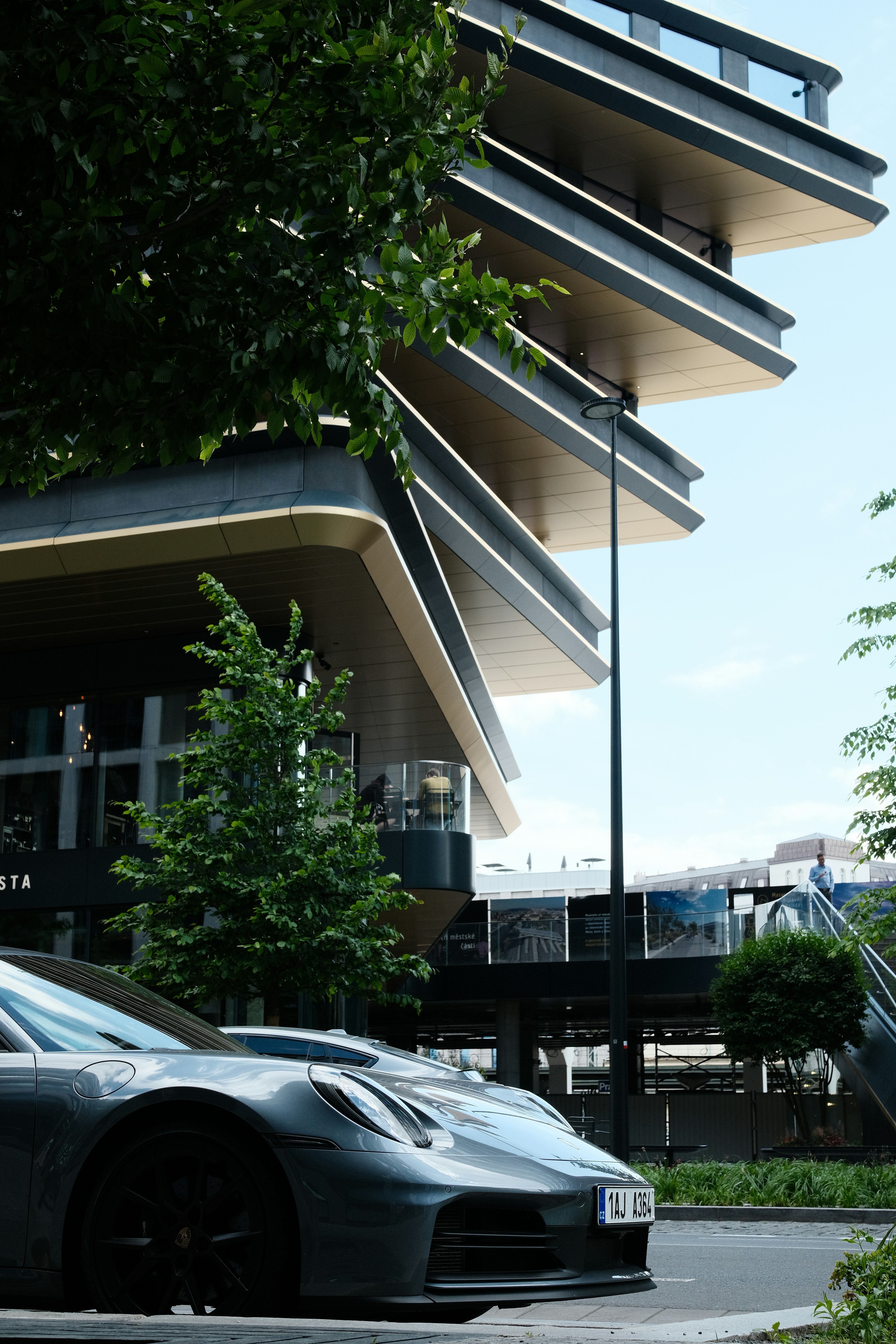 Architectural Angles: A Sportscar at the Foot of a Modern Terrace
