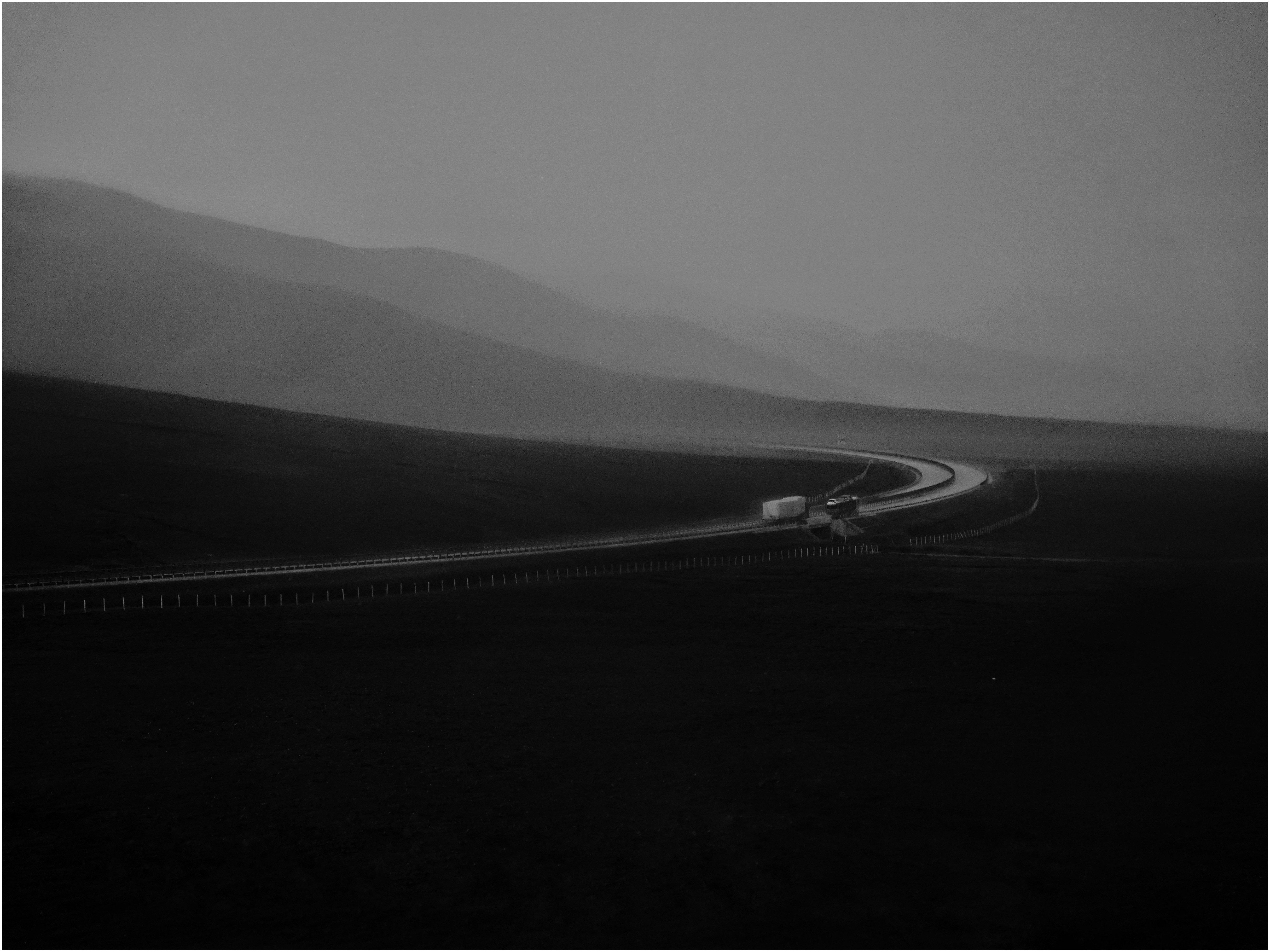 Lonely Highway through Dim Valor: A Monochrome Descent into Distant Ridges