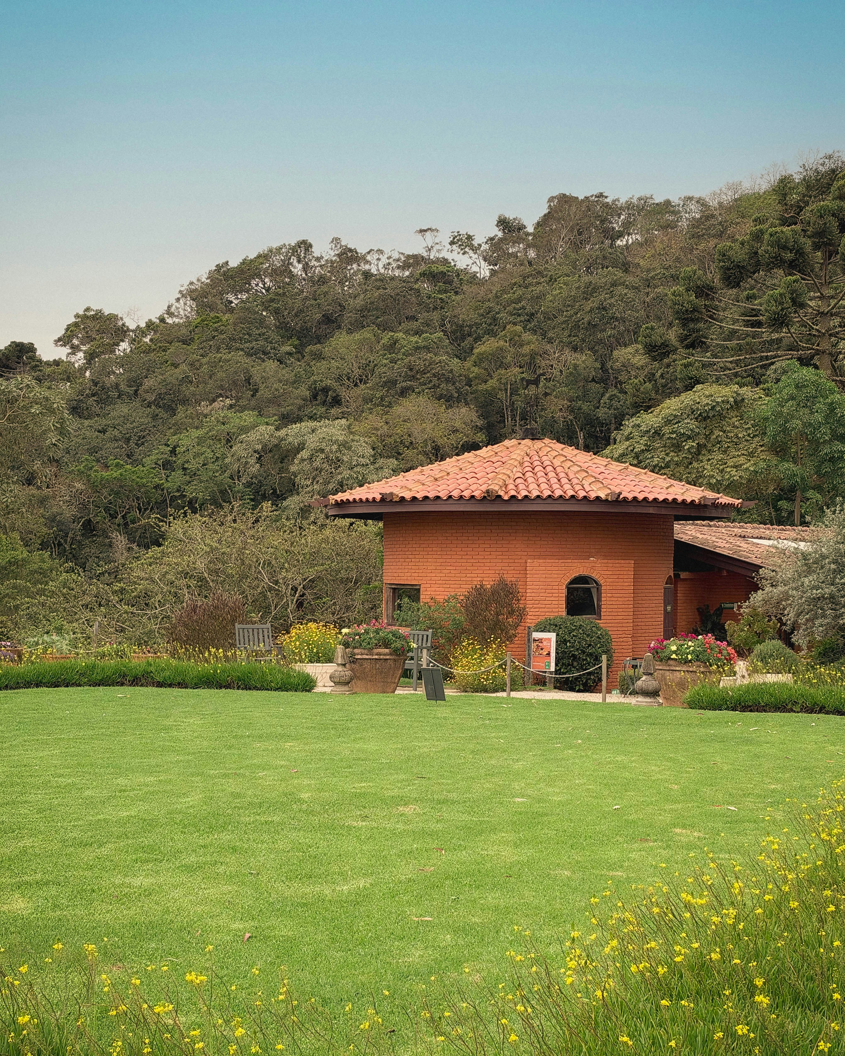 Terracotta-roofed hut by the garden’s edge