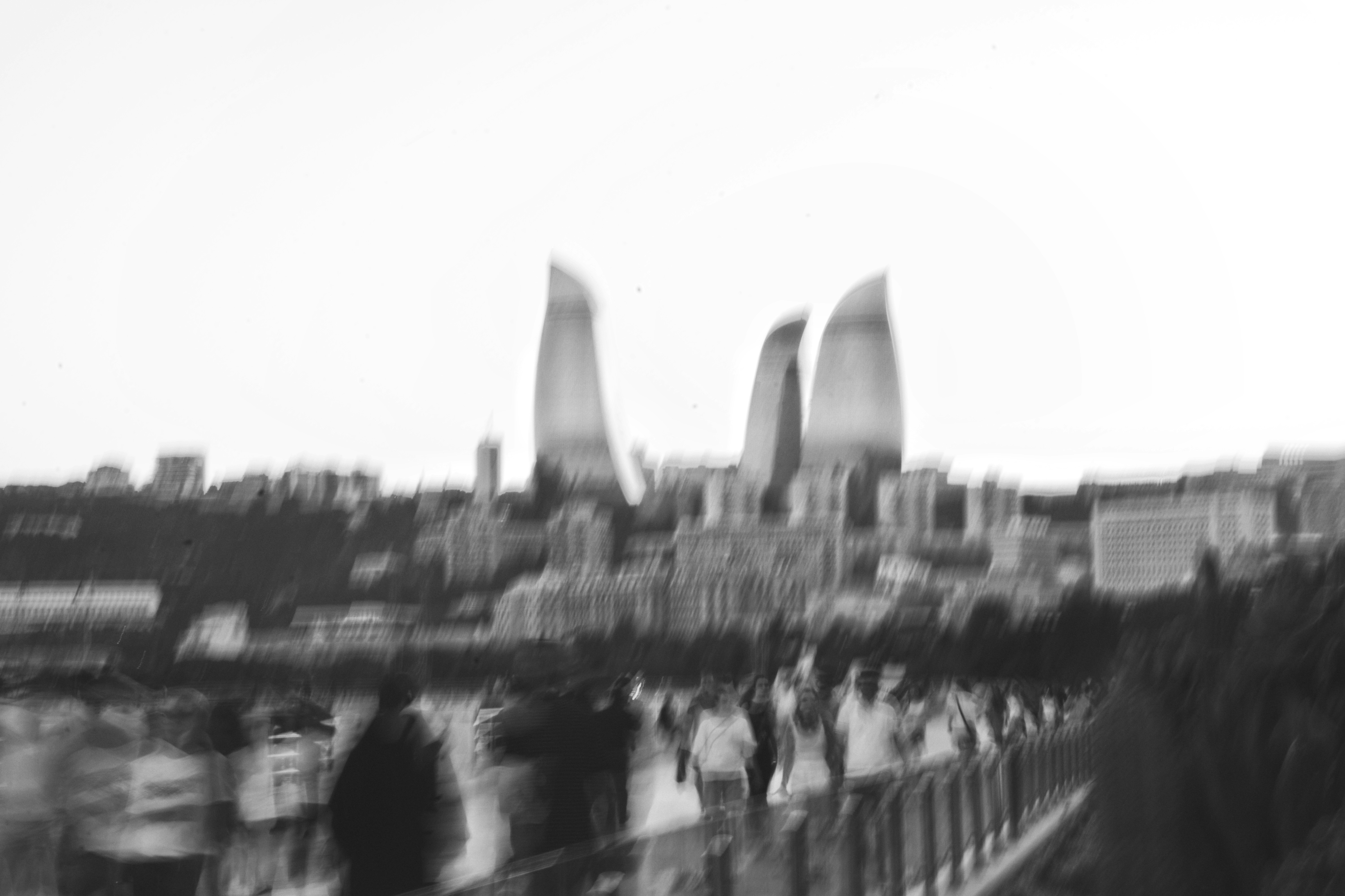 Blurry Waterfront Shuffle Under Skyscraper Silhouettes
