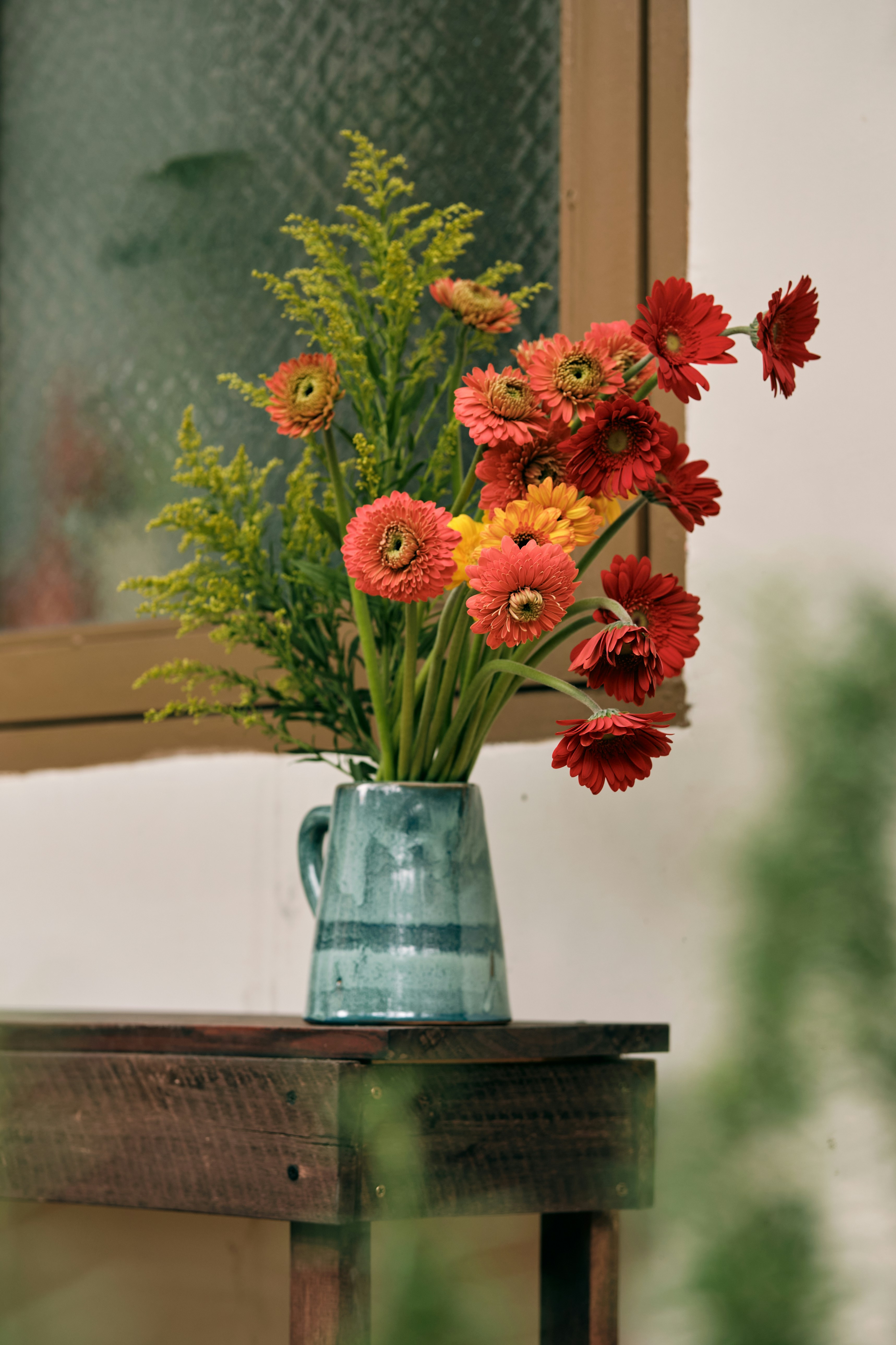 Hydrangea in a Teal Jug: Colorful Florals on a Wooden Surface