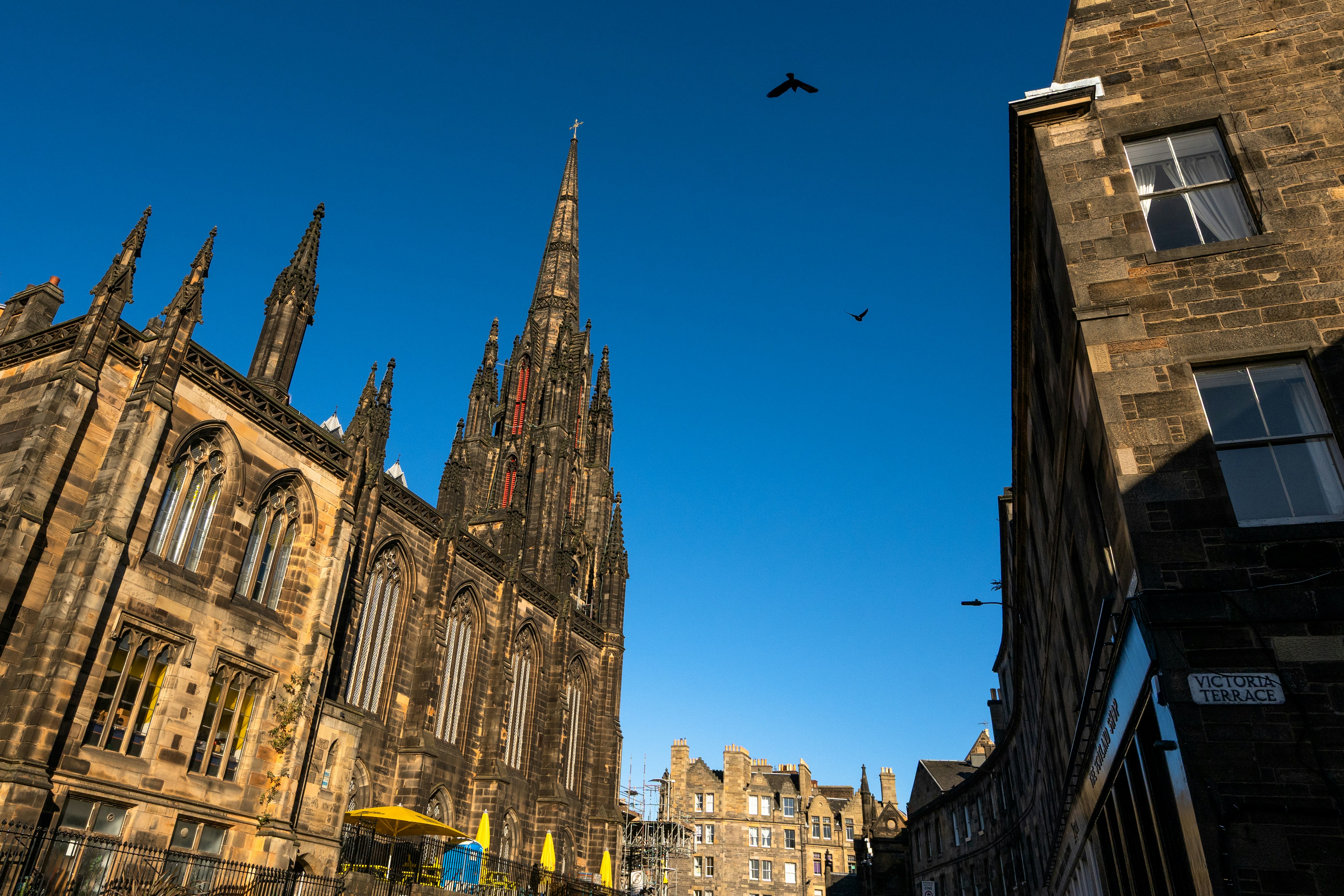 Gothic Majesty: Cathedral Spire Framed by City Façade