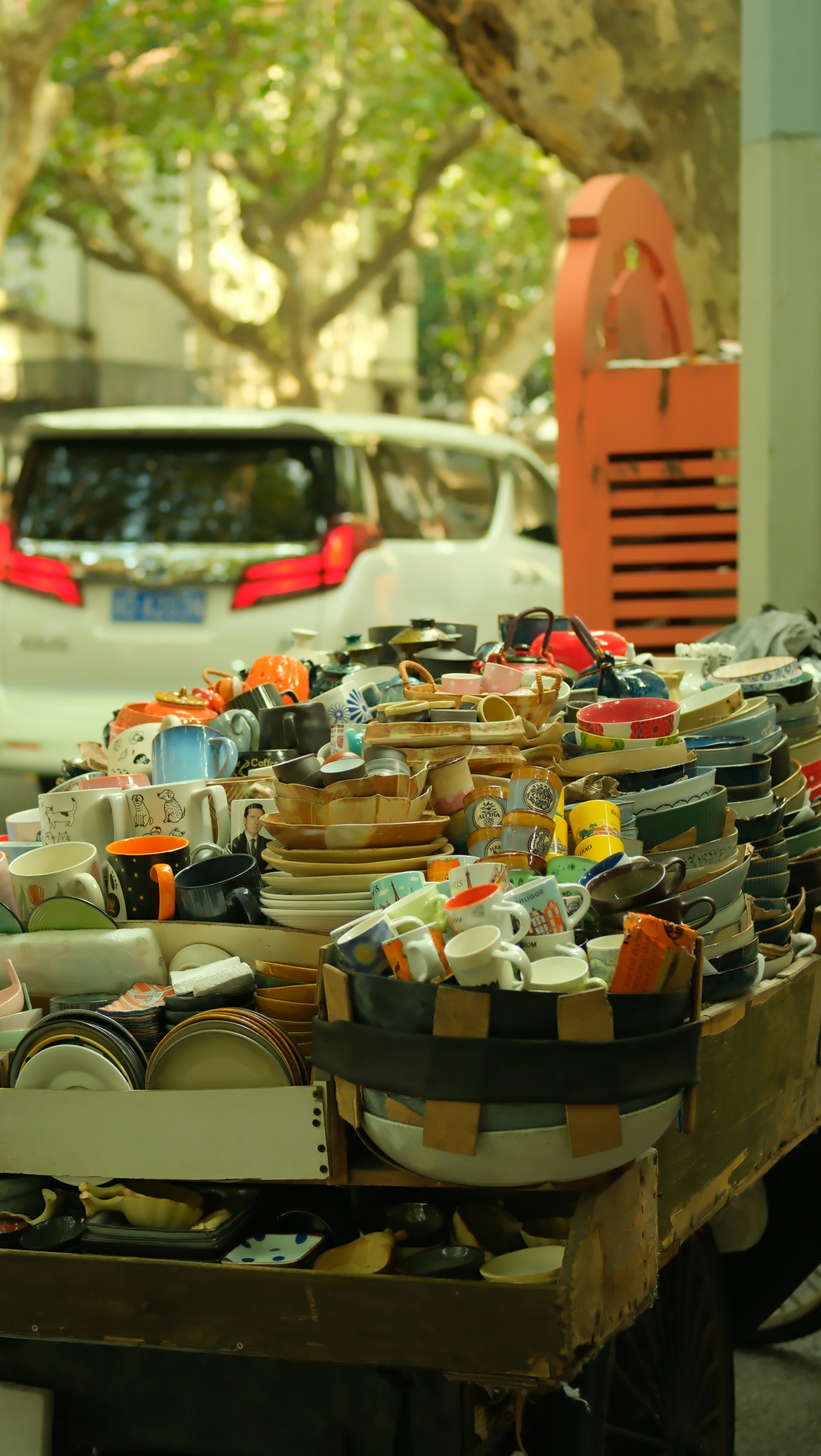 Colorful Uprooted: A Street Cartop Plethora of Mismatched Mugs