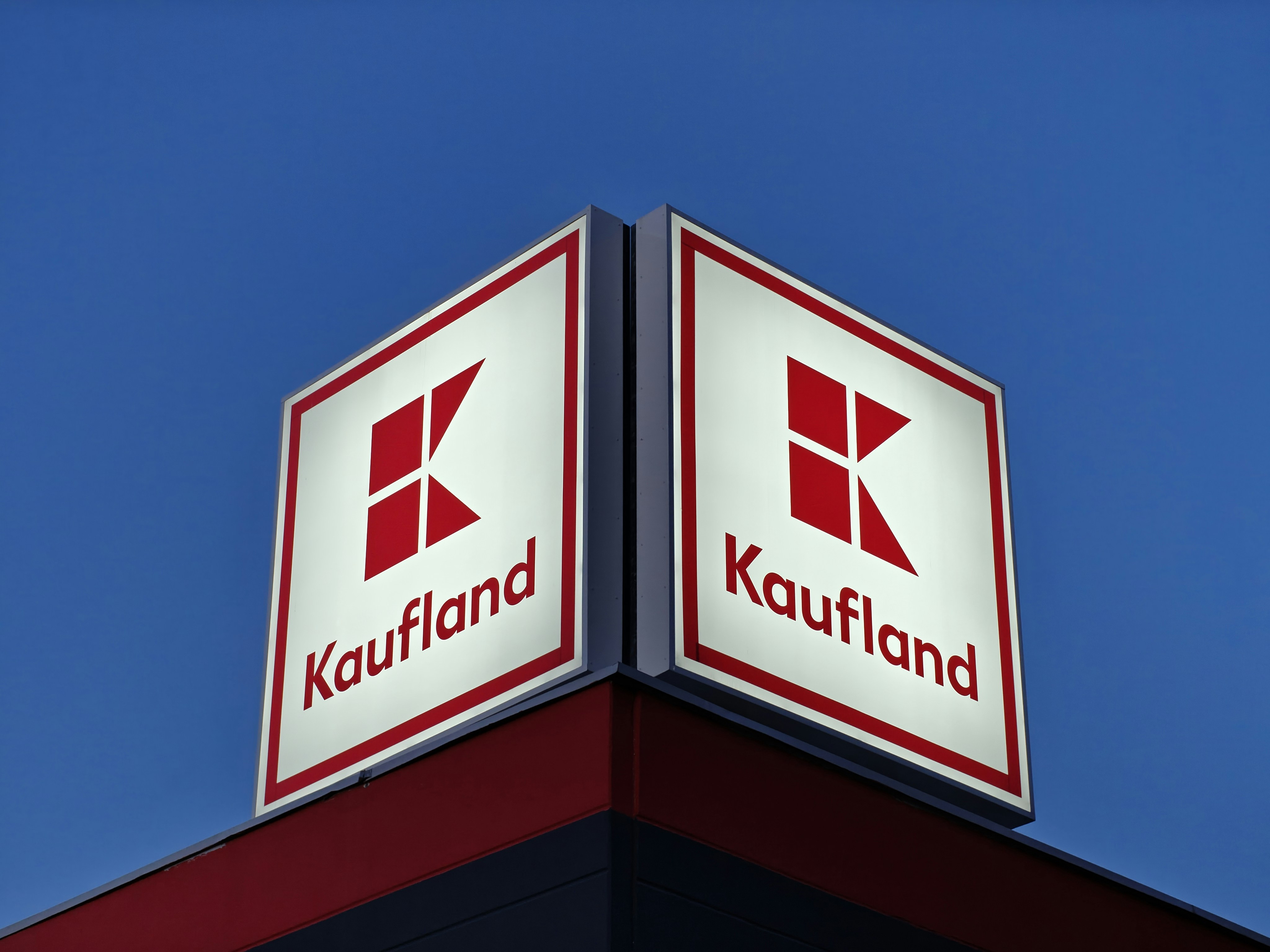 Kaufland Crest: A Corner-Store Identity Against a Clear Sky