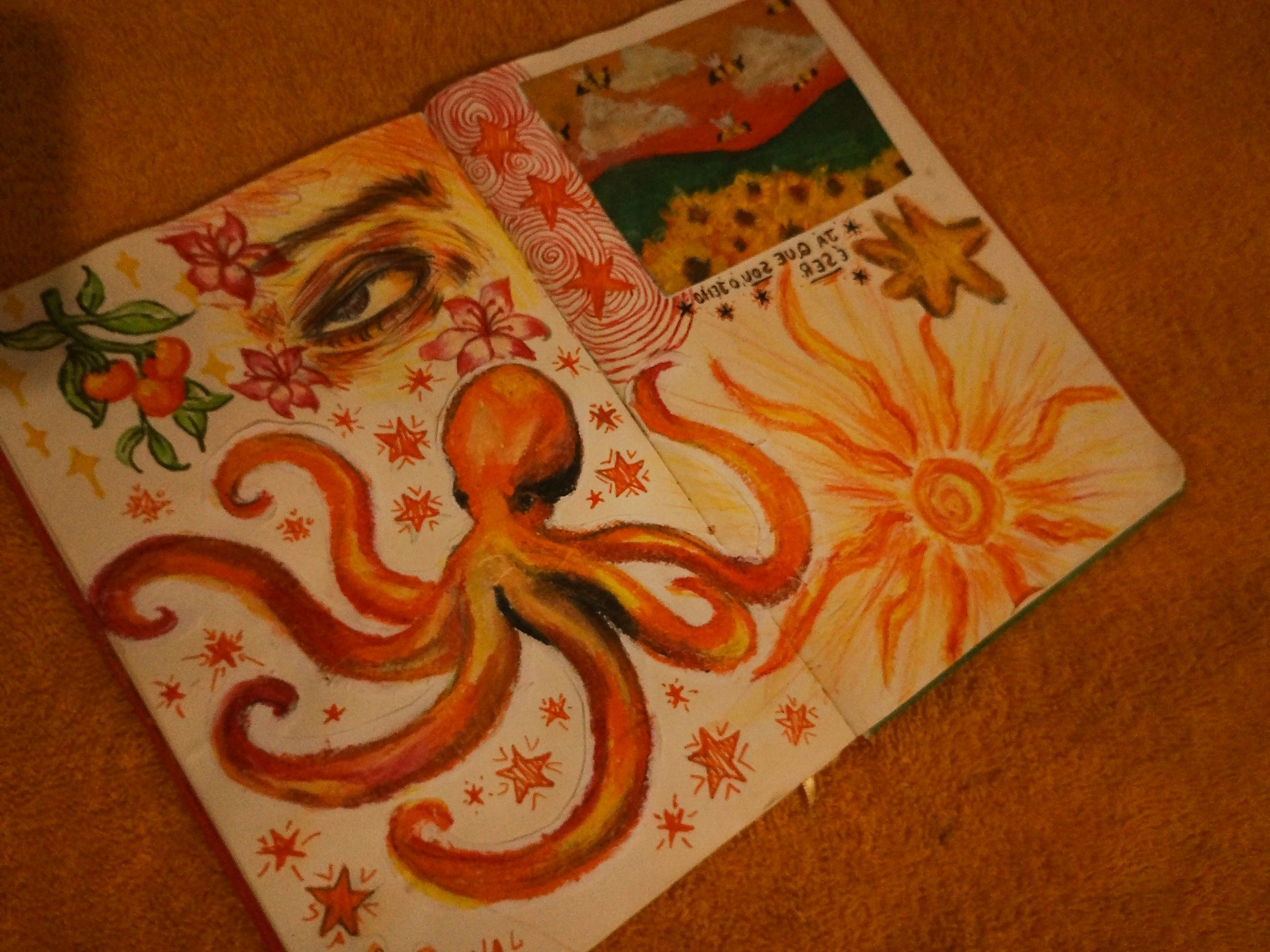 A sketchbook page with a drawing of an octopus, a human eye, and a sun