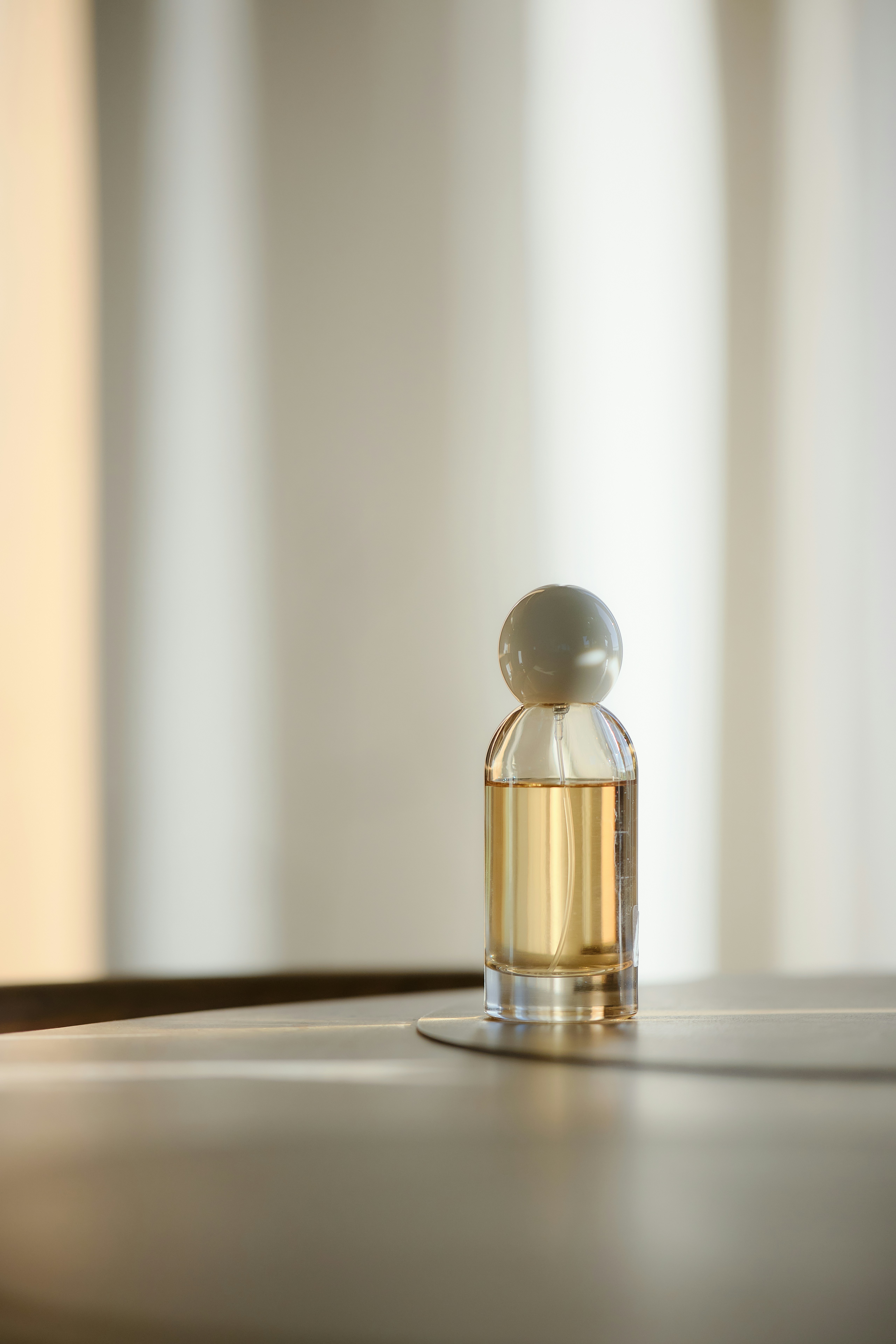 Glass Sphere atop a Golden Bottle: Still Life of Quiet Illumination