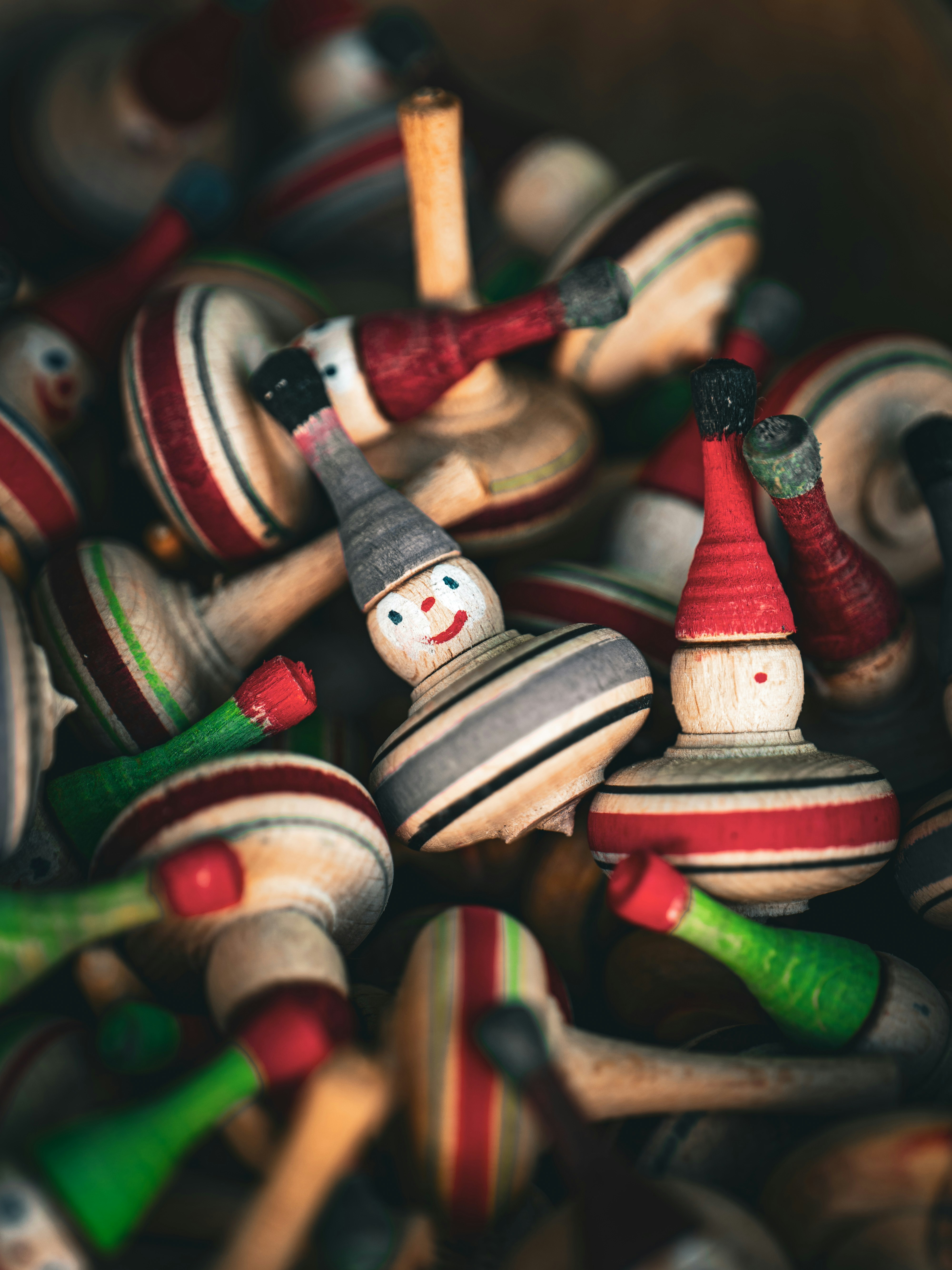 Smiling Nutcracker Among a Sea of Whimsical Wooden Spinners