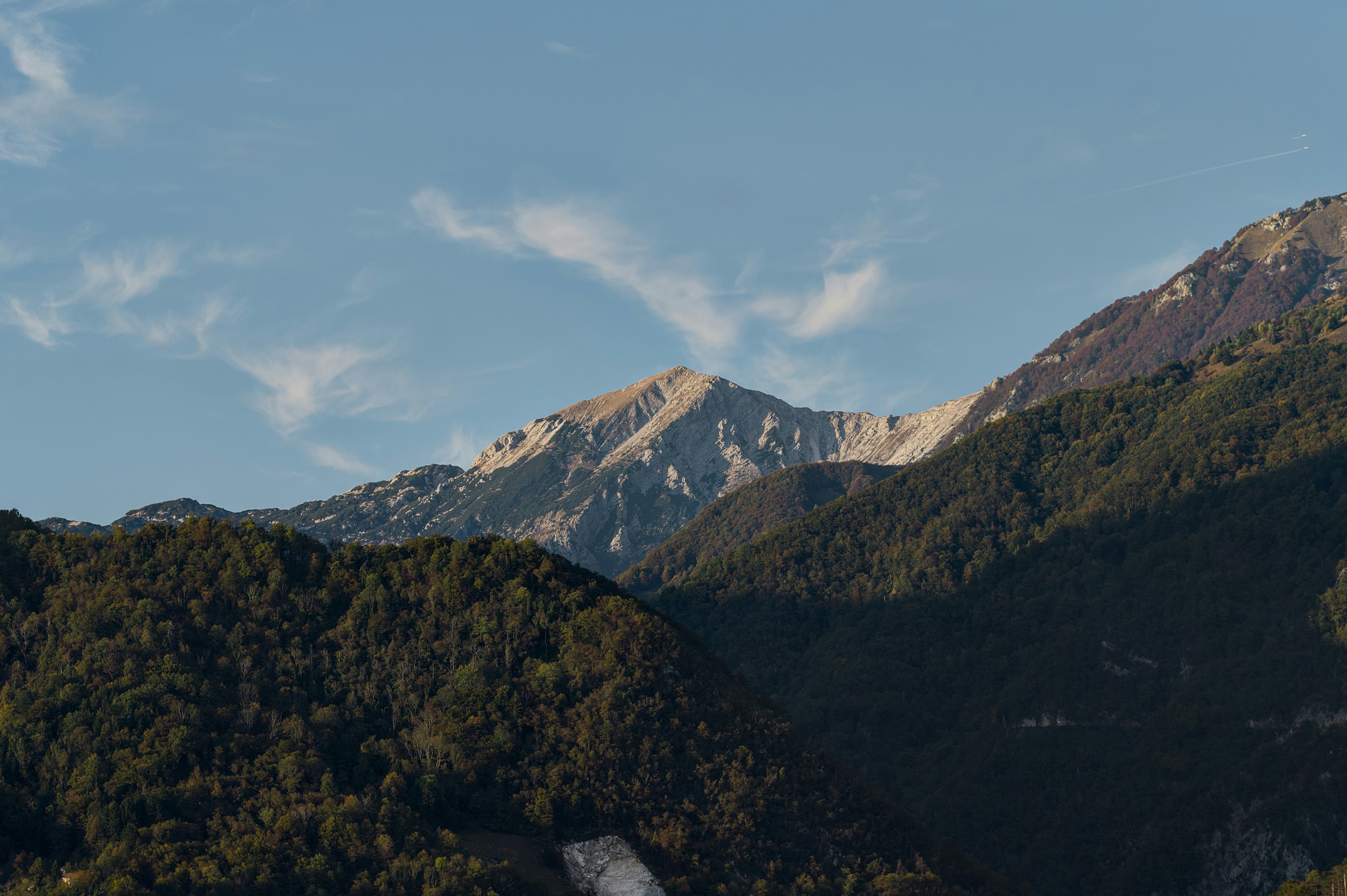Ridge Line at Dusk: Snow-capped Peaks Against a Clear Sky