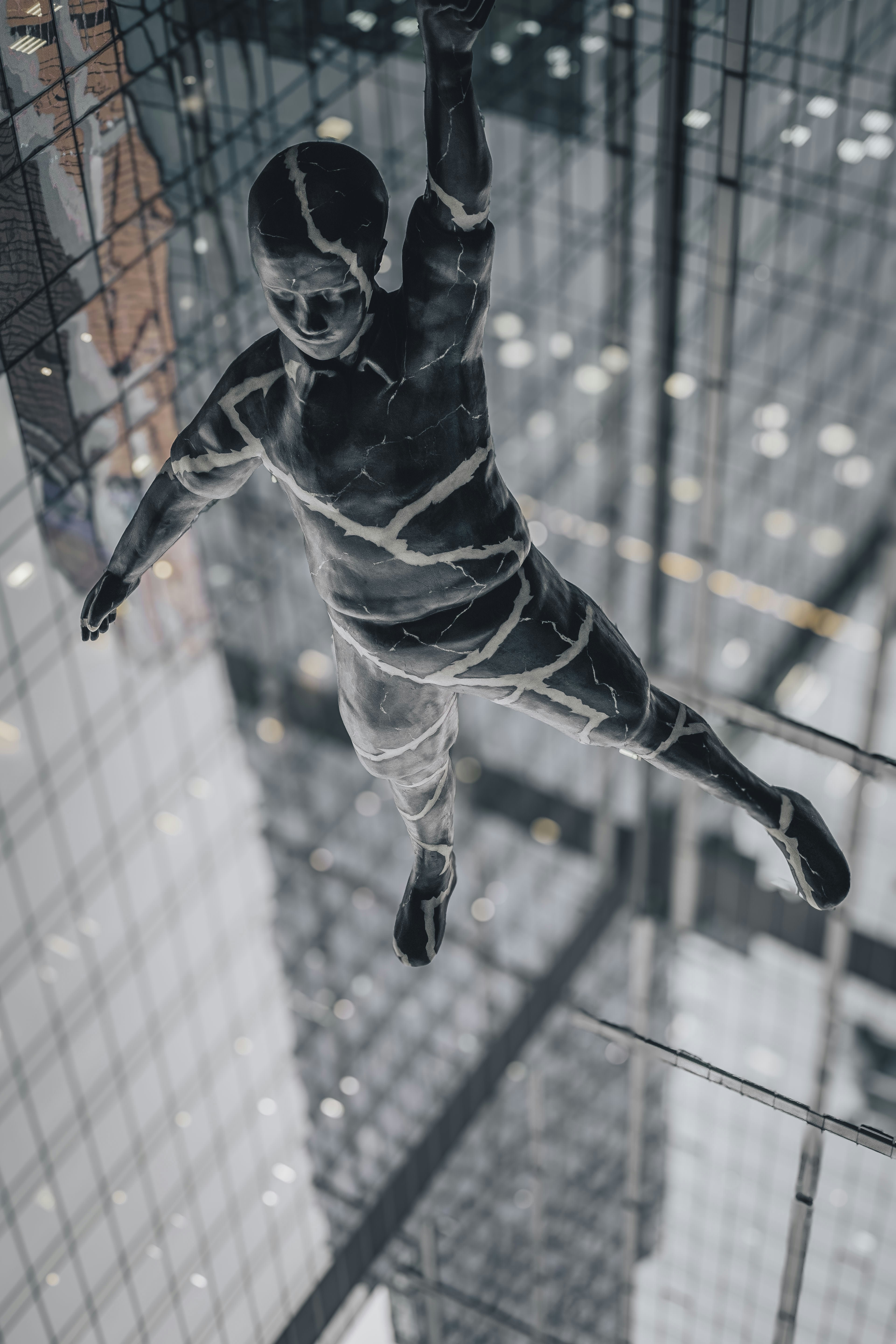 Cracked Gravity: a suspended figure in glass and steel