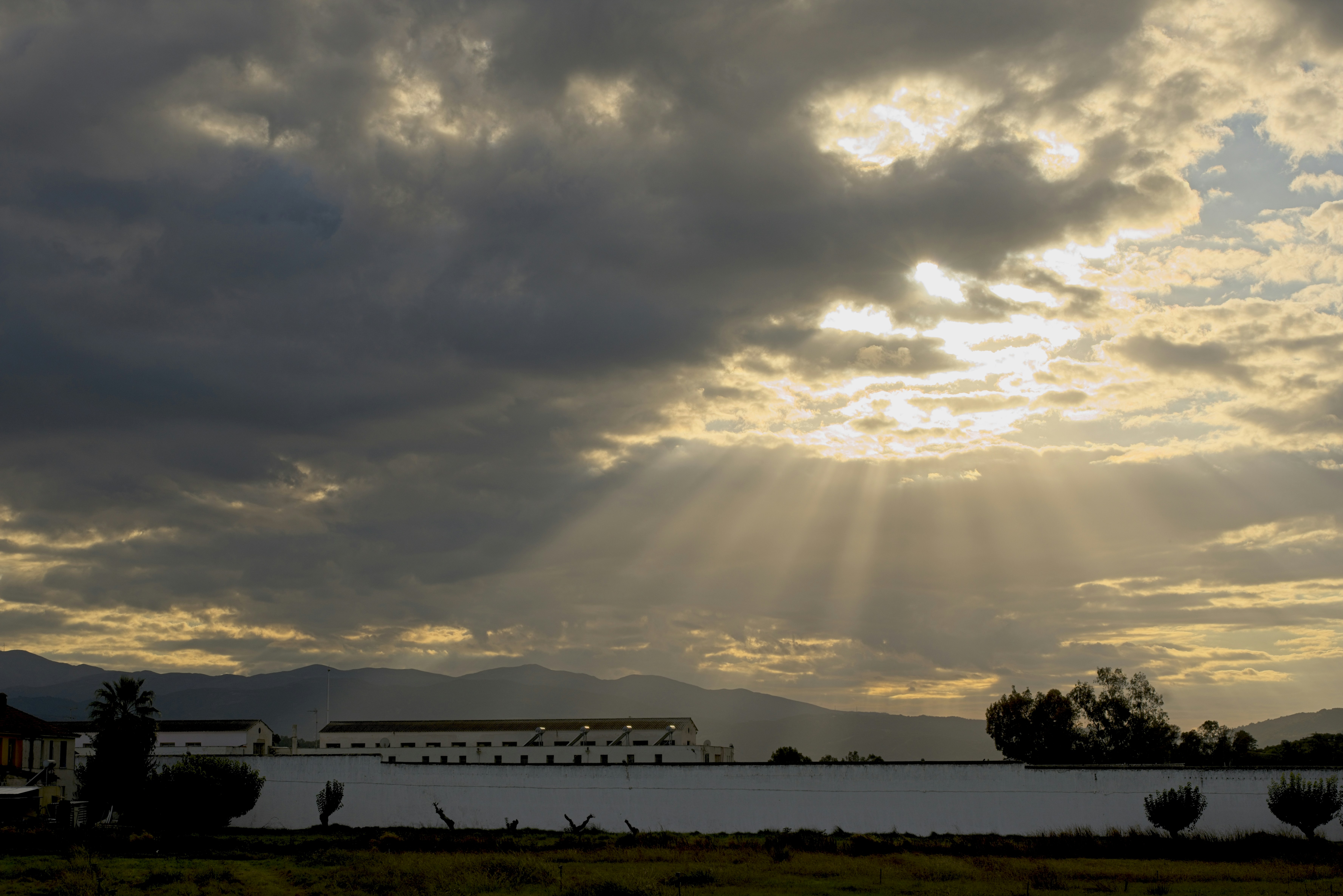 Sunbeams Through Break in Clouds Over Silent Lake