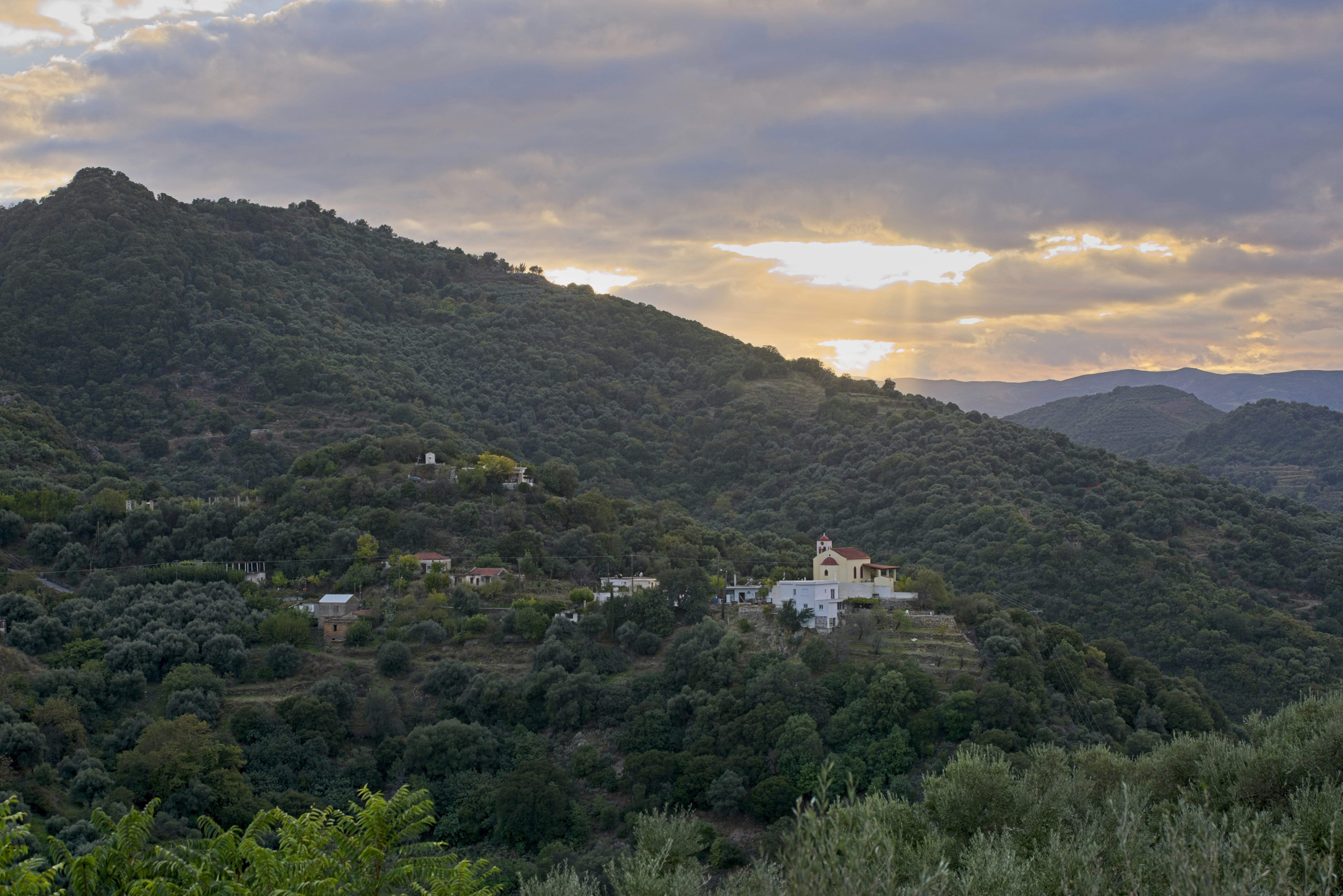 Hilltop White House on a Terrace Under a Sunset Sky