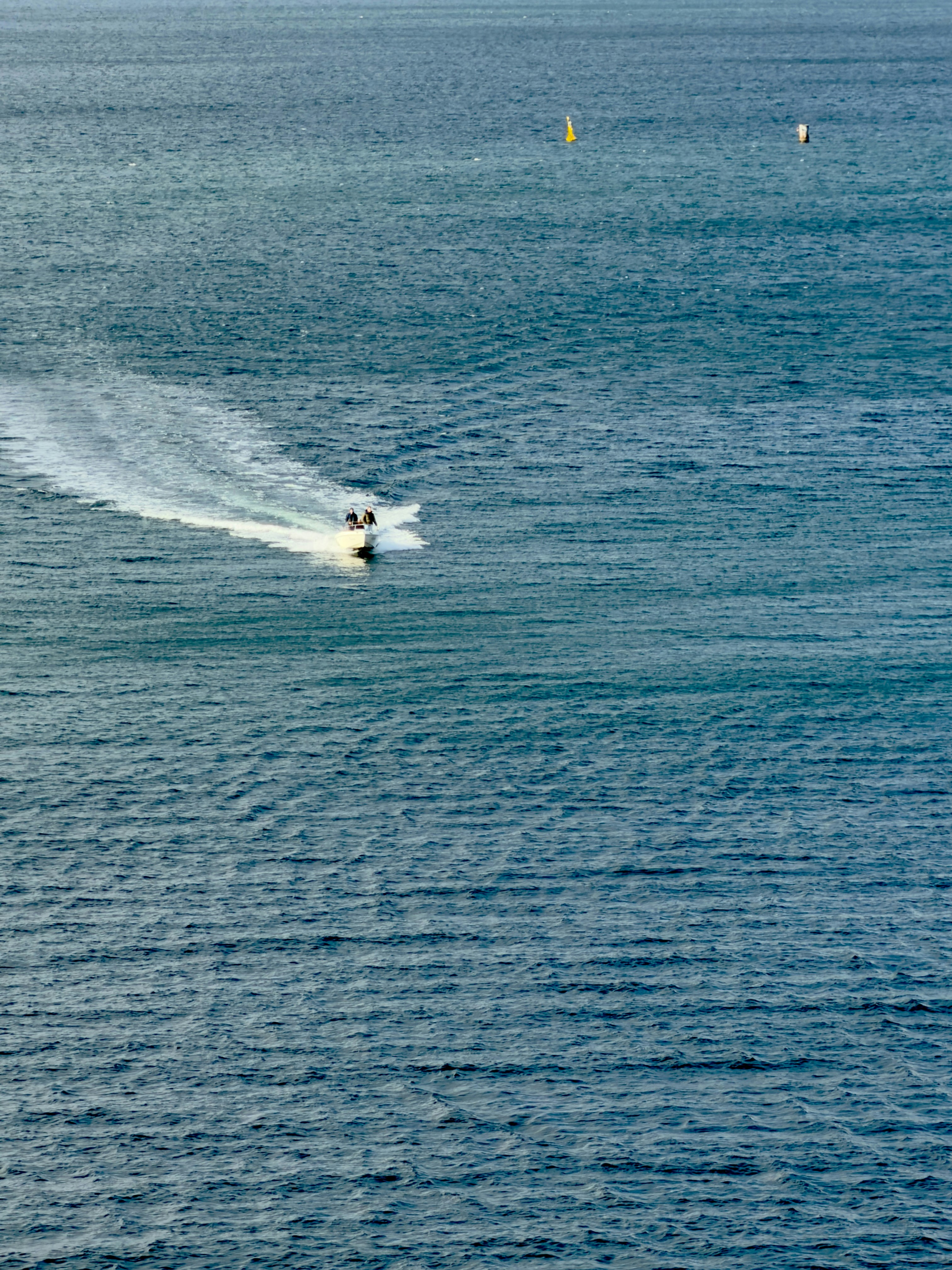 Smooth Wake: a lone rider carving across open sea