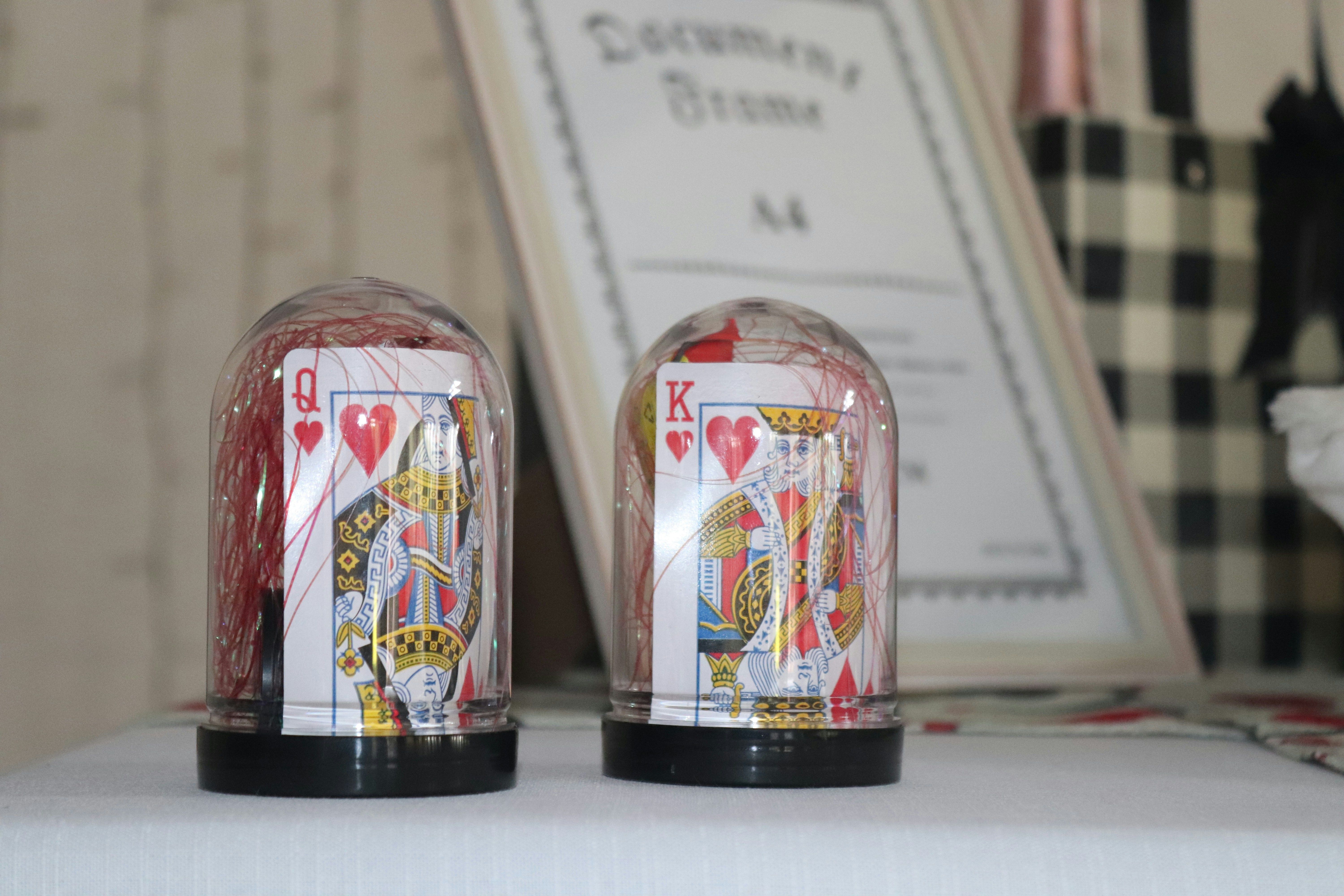 Twin Queens Under Glass: Carded Echoes on a Tabletop