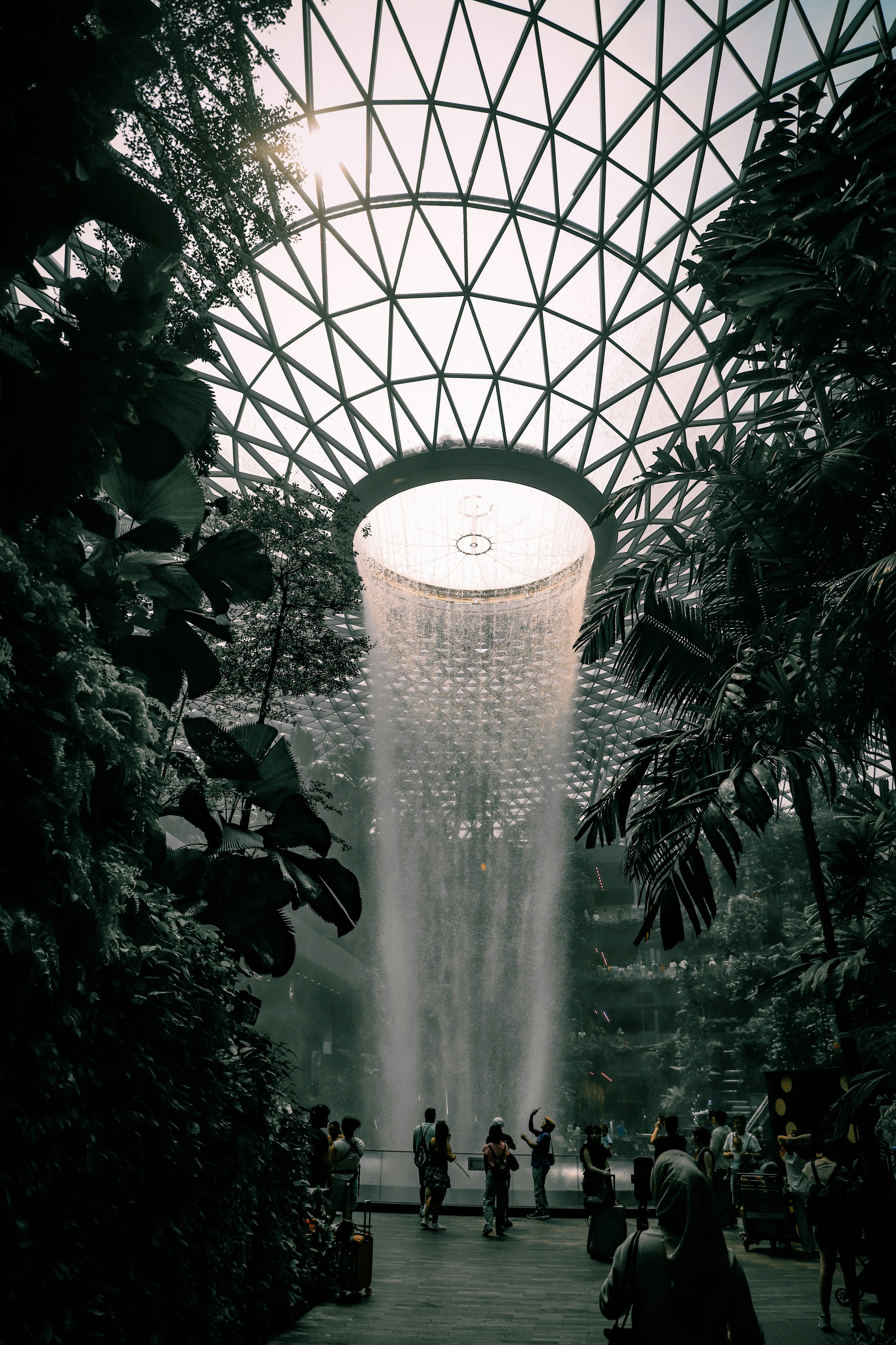The Rain Vortex waterfall cascading from a glass dome roof in Singapore
